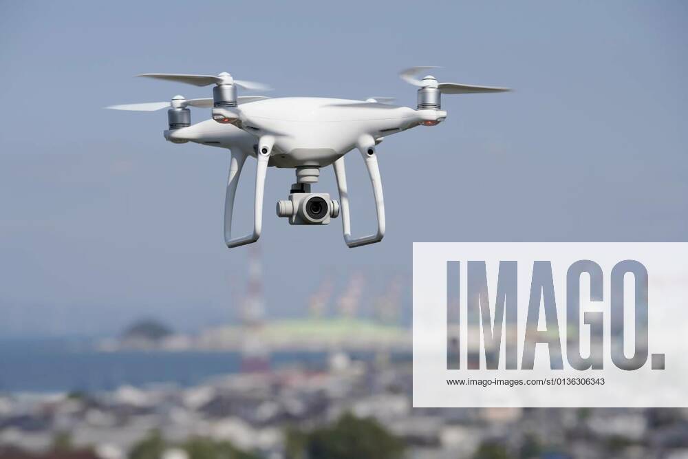 White drone flying over the city with digital camera, Kagawa, Japan