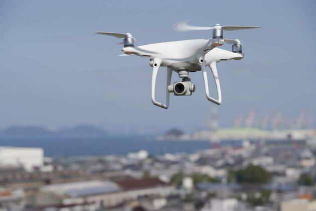White drone flying over the city with digital camera, Kagawa, Japan