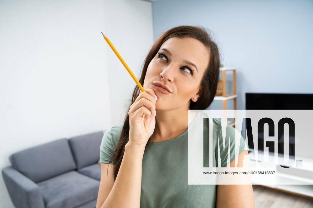 Thoughtful Young Woman In Living Room Model Released Symbolfoto