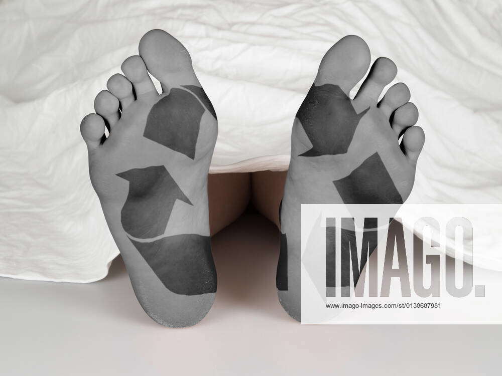 Dead body under a white sheet, concept of sleeping or death, recycle symbol