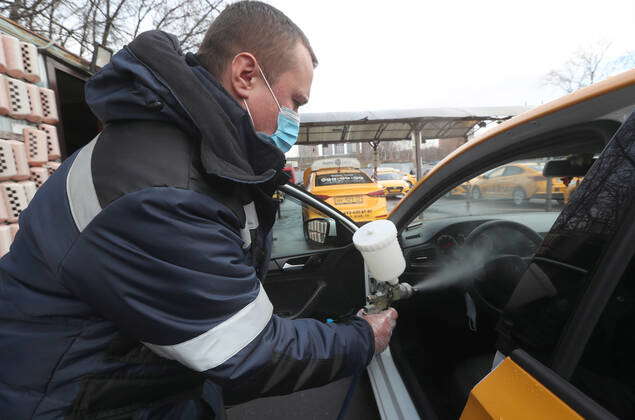MOSCOW, RUSSIA - : A driver carries out disinfection of an Uber taxi ...