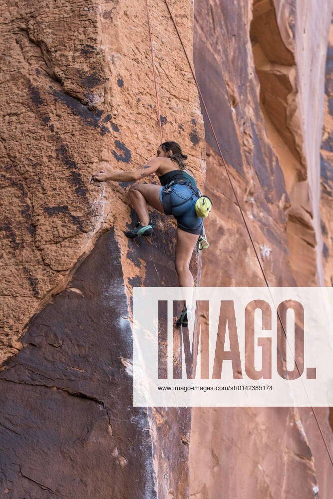 A woman rock climber on the very difficult Under the Boardwalk route on ...