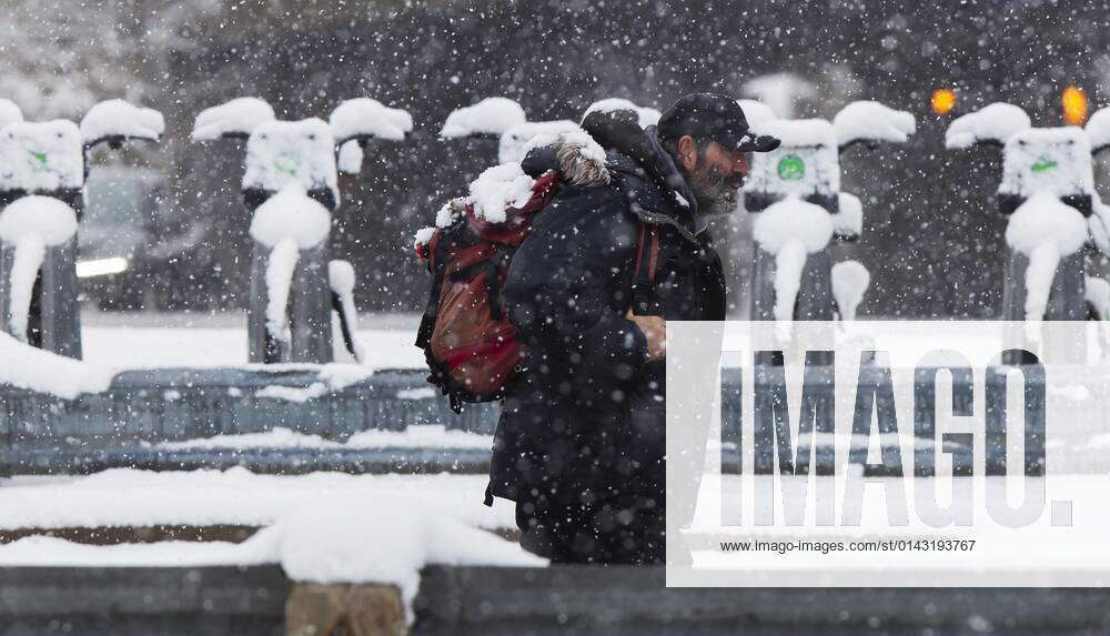 TORONTO, Nov. 28, 2021 -- A man walks on a street during a snowy day in ...
