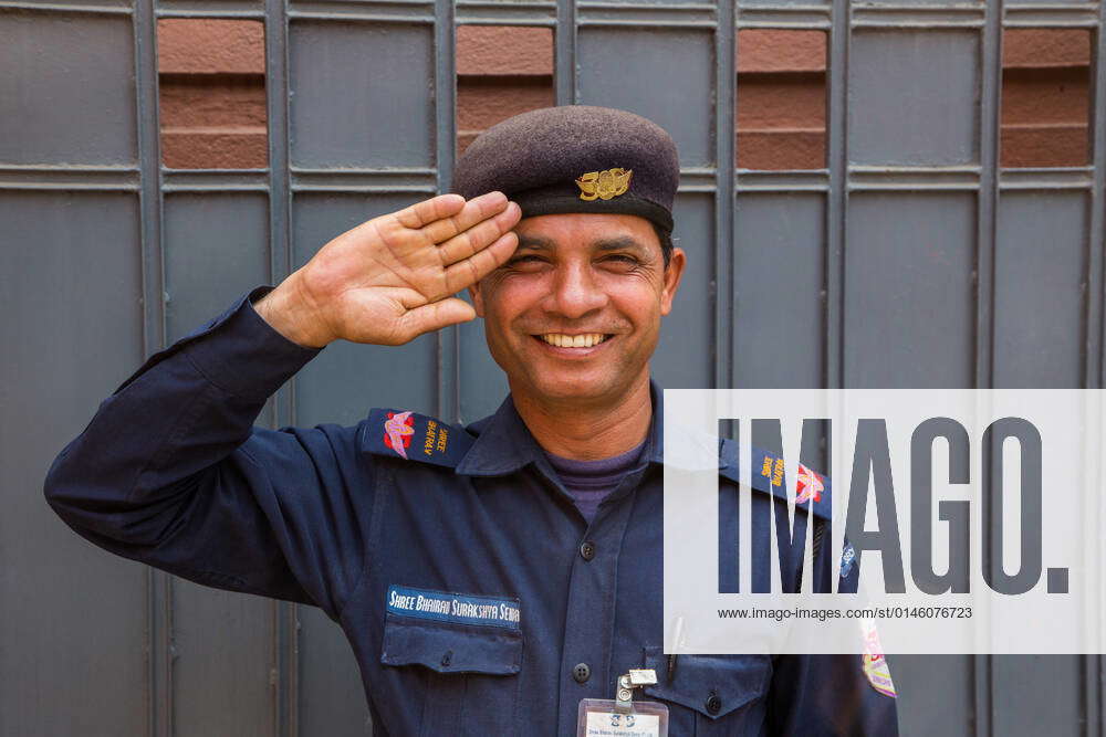 A uniformed private security guard salutes with a smile at a business ...