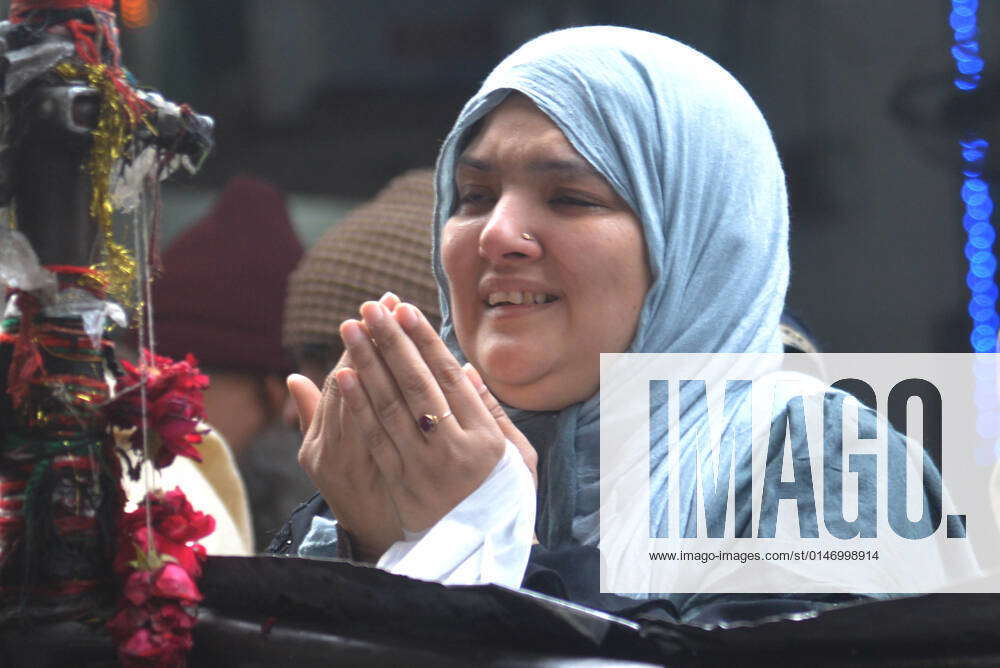 Devotees bring water for ablution of the graves at the shrine of the ...