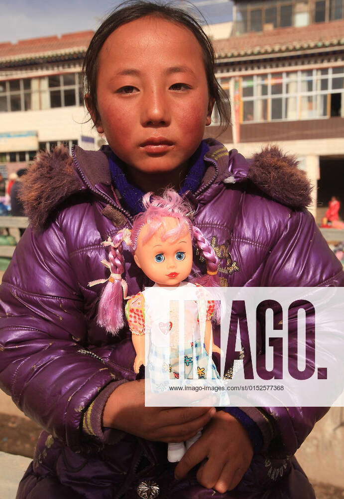 February 6, 2012, XIAHE, GANSU PROVINCE, CHINA: A Tibetan girl holds ...
