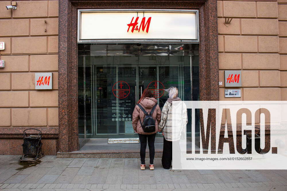 Moscow, Russia: Girls stand in front of the closed doors of the H&M ...