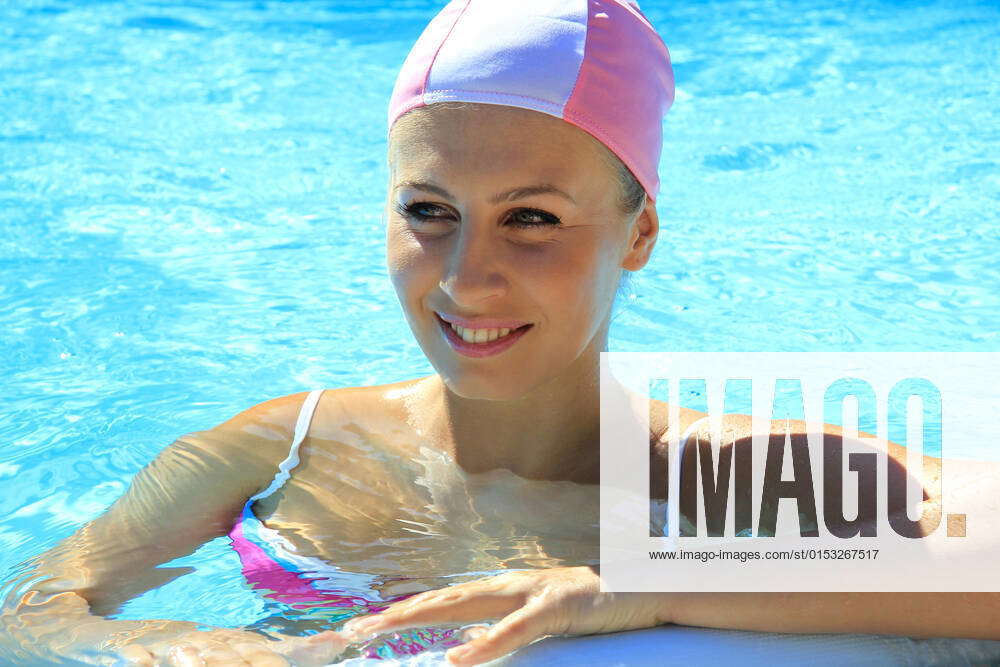 Woman with bathing cap refreshes herself in pool, portrait, Tuscany ...