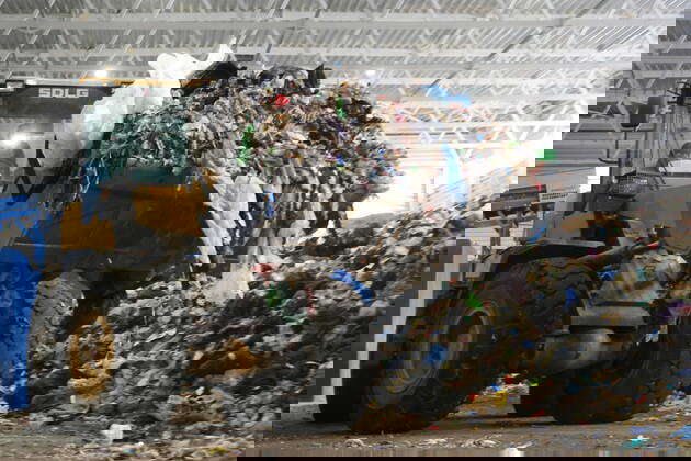 MOSCOW REGION, RUSSIA – : A wheel loader driver unloads waste at the ...