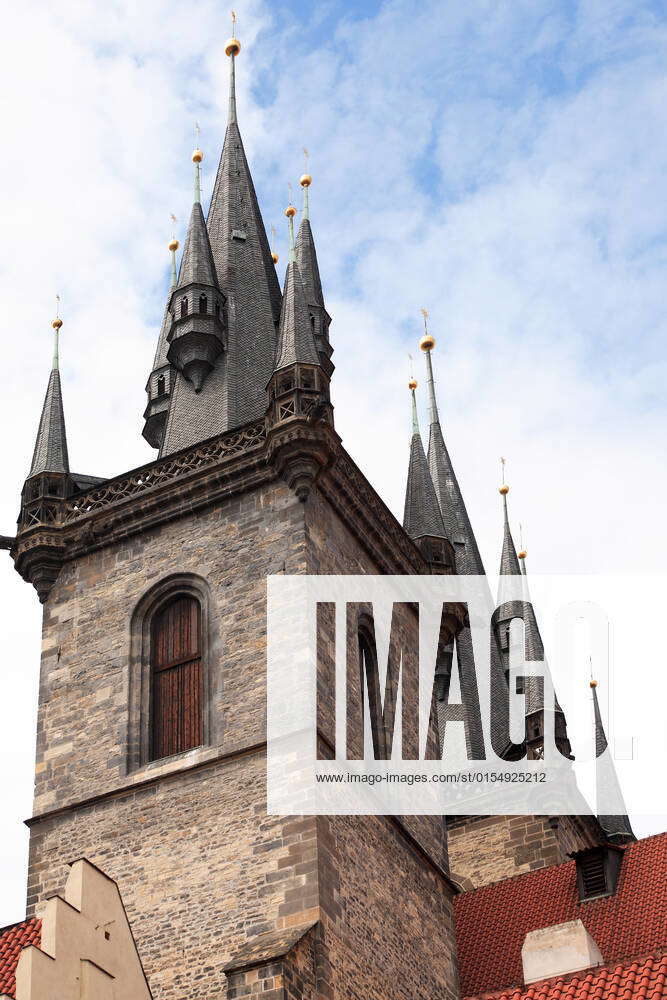 Classical gothic architecture. Red tiling roofs near high ancient ...