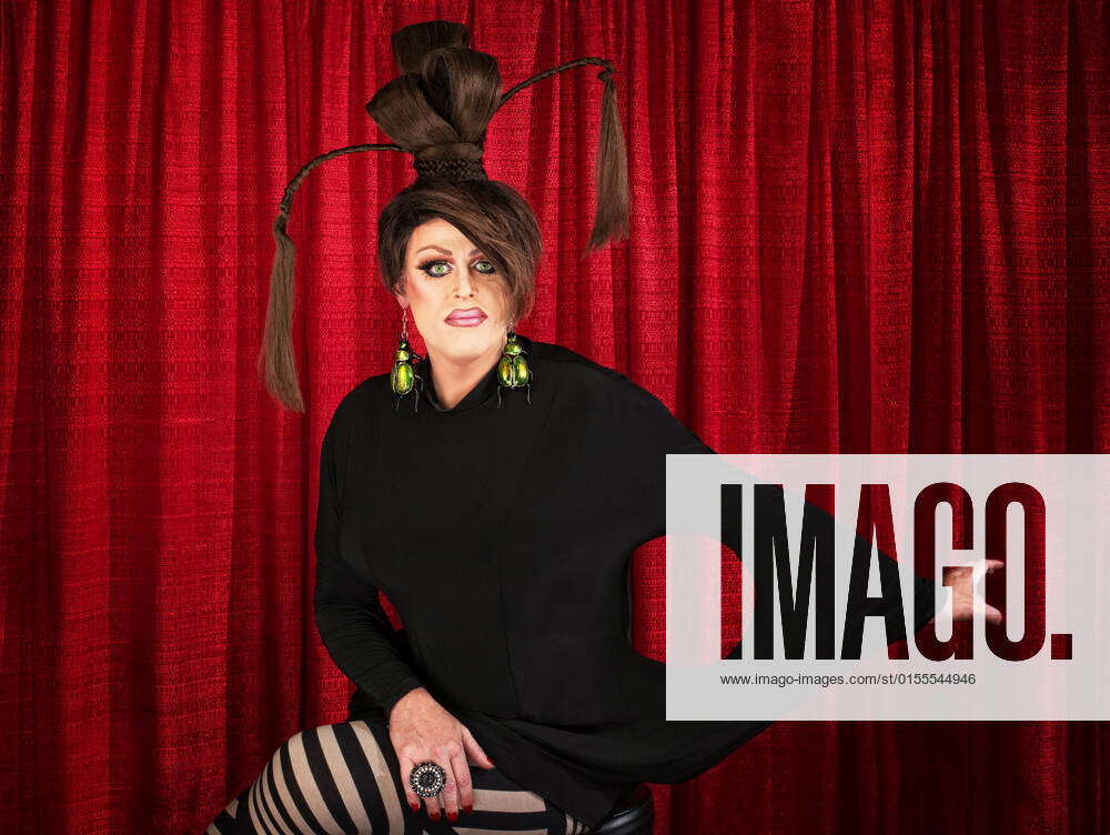 Grinning man in drag with unique dress and ponytails, model released ...