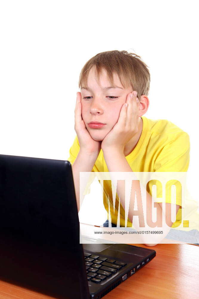 Bored Kid at the Desk with Laptop Isolated on the White Background ...