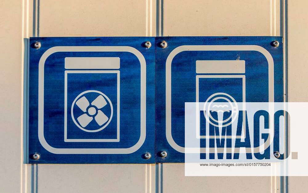 Signs showing illustration of washing machine and dryer, white and blue ...