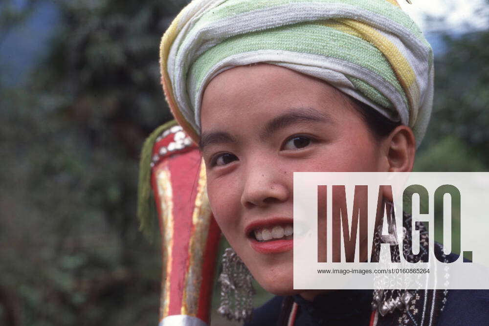 July 1 1997, China: Young woman posing for picture. The Laotian ...