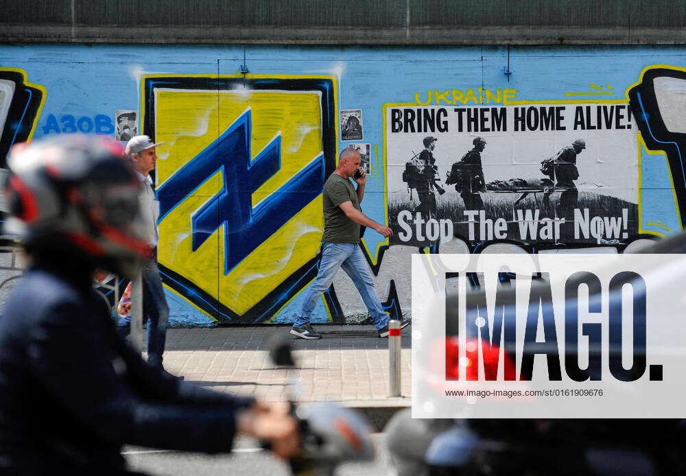 June 30, 2022, Kyiv, Ukraine: A man walks past a graffiti depicting the ...