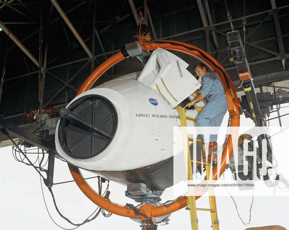 Richard F. Gordon Jr. climbing into training simulator. Astronaut ...