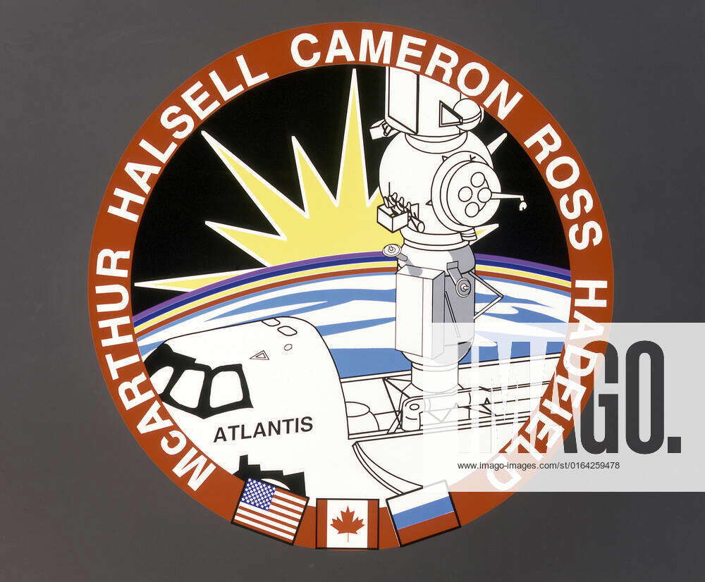 The STS-74 crew patch depicts the orbiter Atlantis docked to the Russian Space Station Mir. The