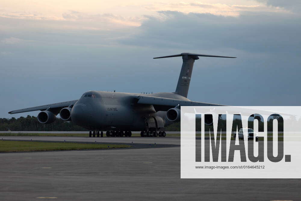 A C-5 transport aircraft arrives at the Shuttle Landing Facility at ...