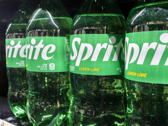 New packaging for Sprite Bottles of Sprite in their green plastic are ...