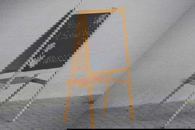 My first day at school, is written on a board, on the schoolyard of the ...