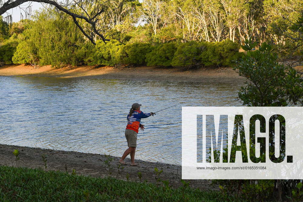 MAPOON FEATURE, A local fishes at Janie Creek, near the main beach, and ...