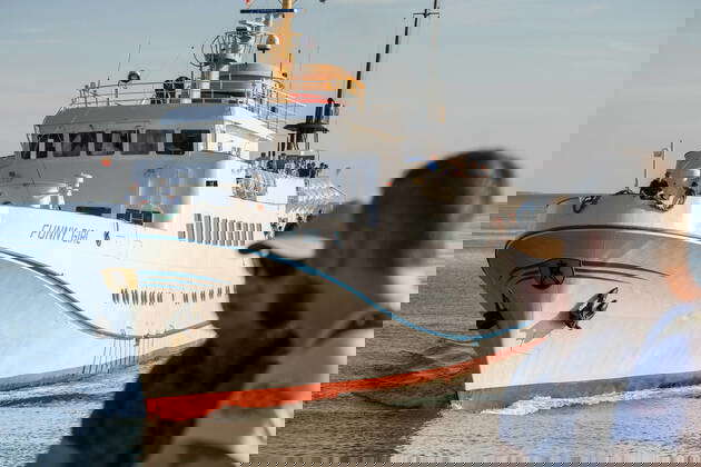 The passenger ship Funny Girl sails here past tourists into the harbor ...