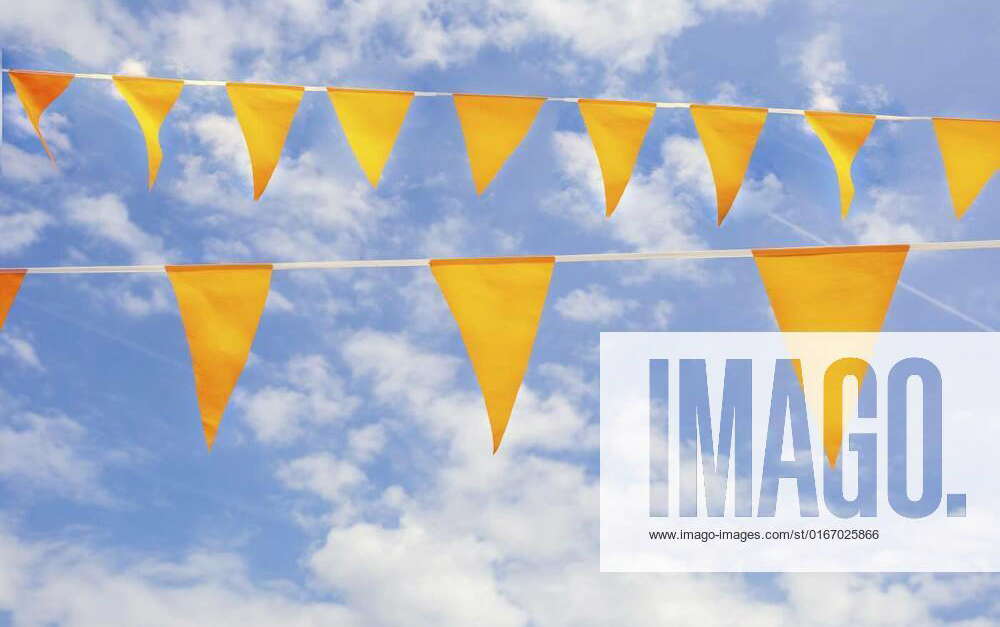 Flags in Dutch national color orange in the clear blue sky with ...