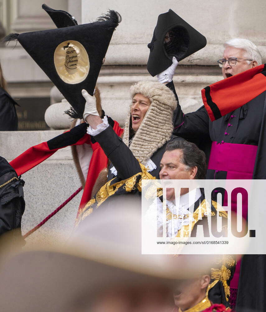 Members of the Coldstream Guards raise their Bearskin hats as they ...