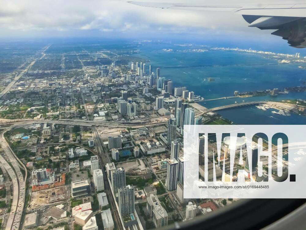 Miami from airplane porthole at day with blue sky, Miami from airplane ...