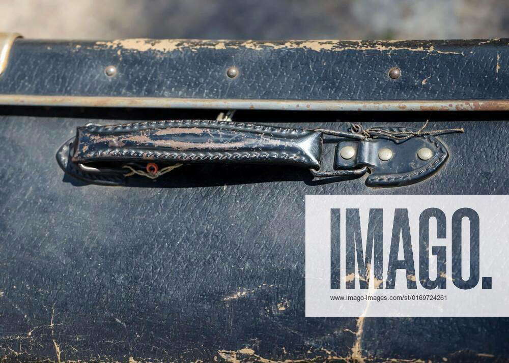 A close-up, detail shot of an old leather suitcase