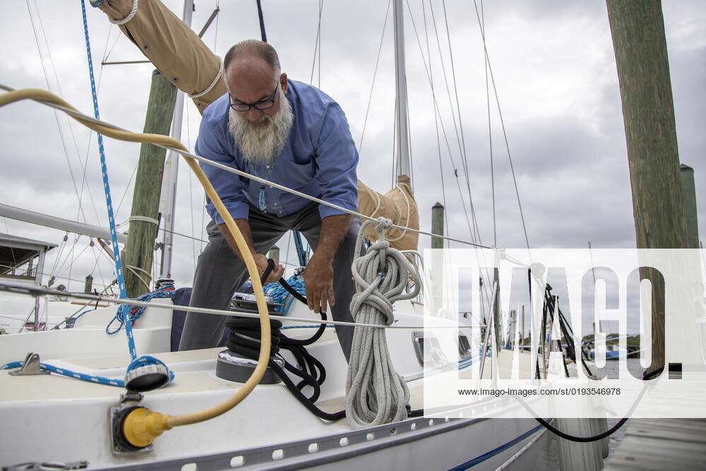 Tampa, Florida, USA: Jon Procter of Ozona, ties down his sailboat ahead ...