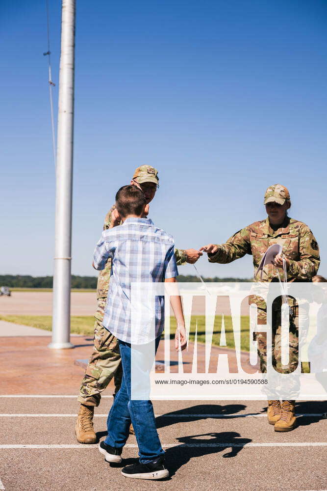 U.S. Air Force Col. Gordon Meyer presents the Home Front Hero Award to ...