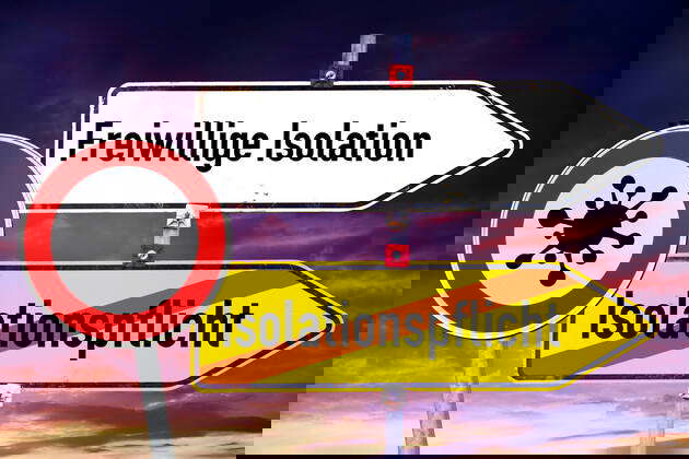 PHOTOMONTAGE, signpost with inscription Voluntary isolation and compulsory