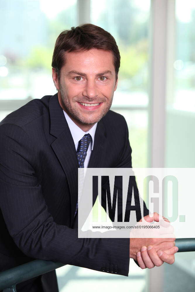 Executive leaning on rail, model released, 8257908, attractive, back ...