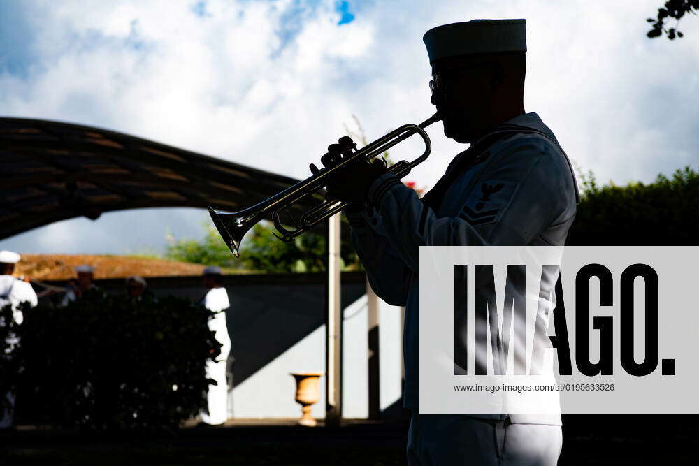 A U.S. Navy bugler, assigned to Navy Region Hawaii, plays taps while ...