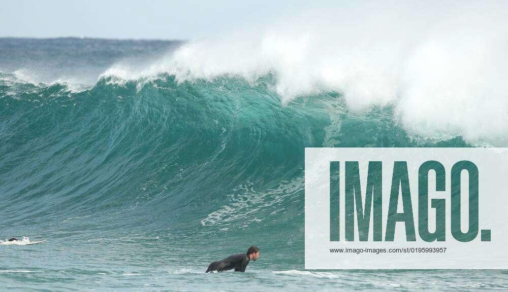 BIG SURF WILD WEATHER, A Surfer duckdives a wave at Snapper Rocks in ...