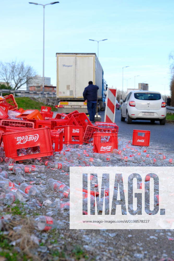 Cases full of Coca Cola bottles fell out of the cargo truck Cases full ...