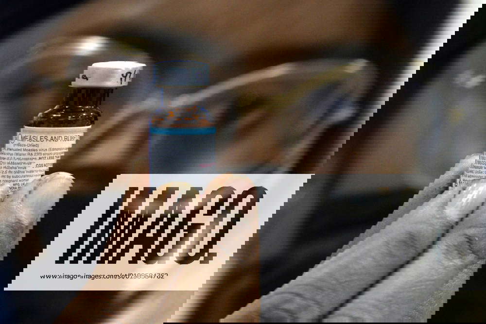 Measles and Rubella vaccination drive Heath worker holds vial of Measle ...