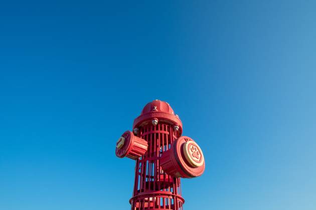 A Giant Red Fire Hydrant at a Dog Park on a Clear Blue Sky, A Giant Red ...