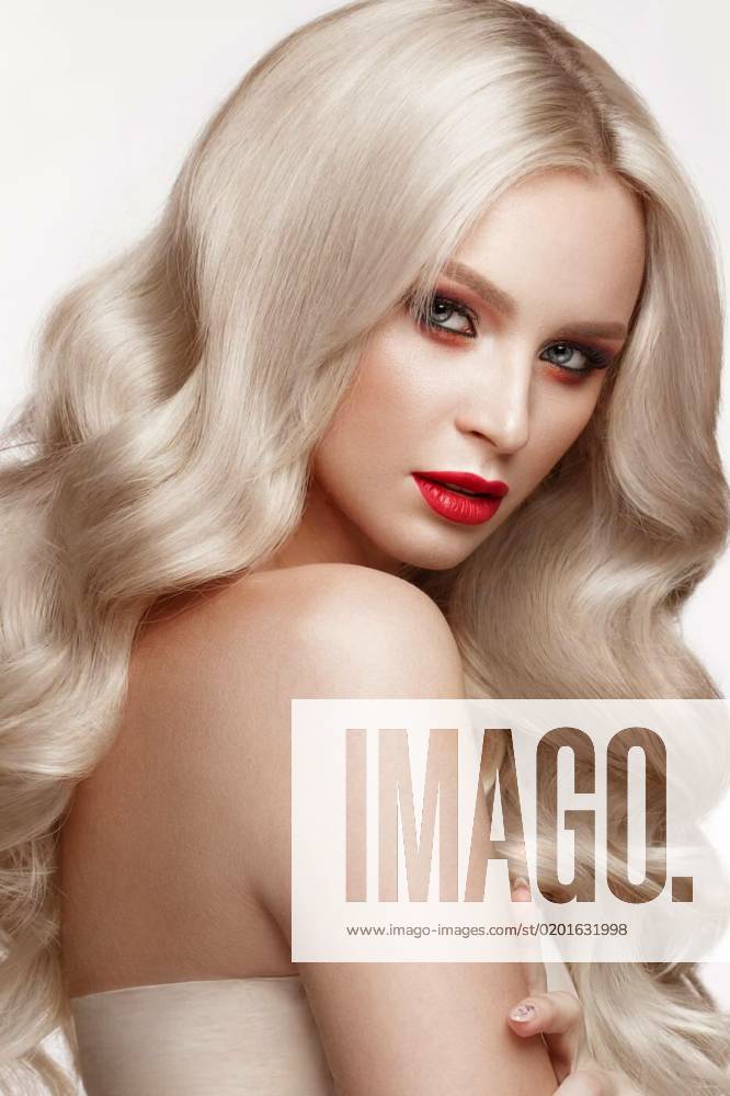 Beautiful Blonde In A Hollywood Manner With Curls Natural Makeup And