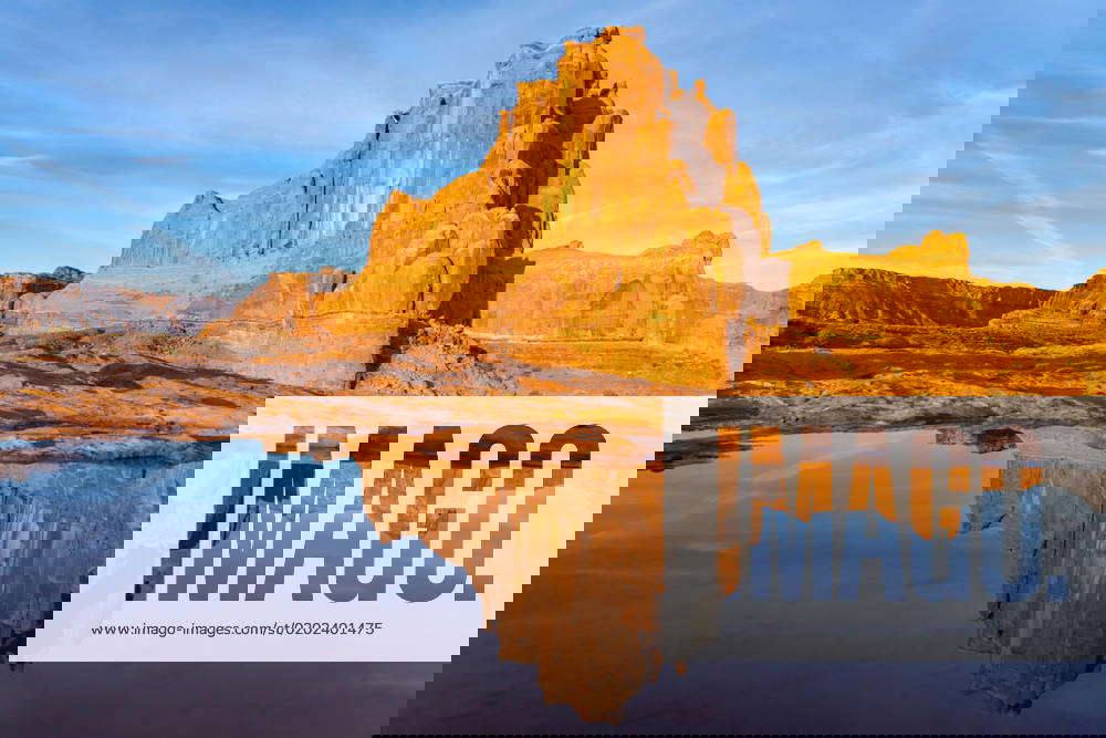 Entrada sandstone rock formation reflected in a rainwater pool in ...