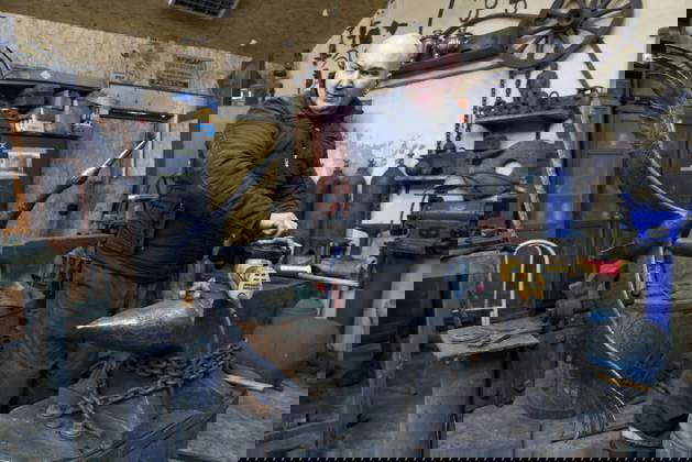 RUSSIA, KRASNODAR REGION - : Blacksmith Denis Milchenko works on Smerch ...