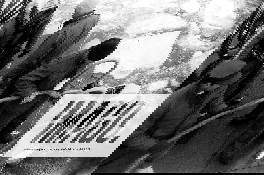 Navy CHIEF Radioman Ron Campbell, wearing Mark 12 dive gear, enters the ...