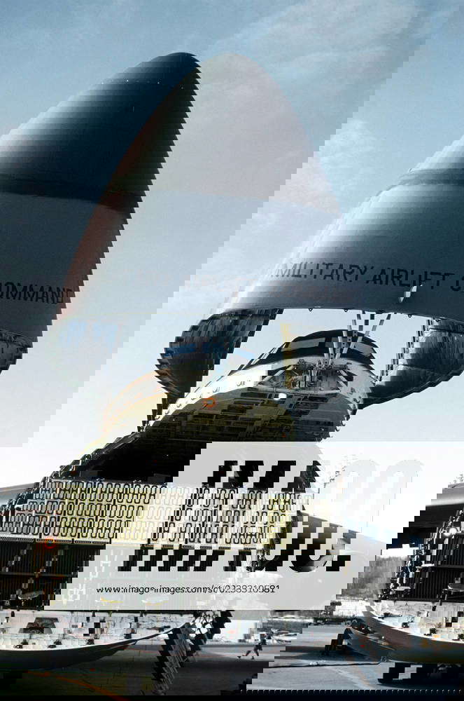 An airman climbs the stairs of a 3rd Military Airlift Squadron C-5B ...