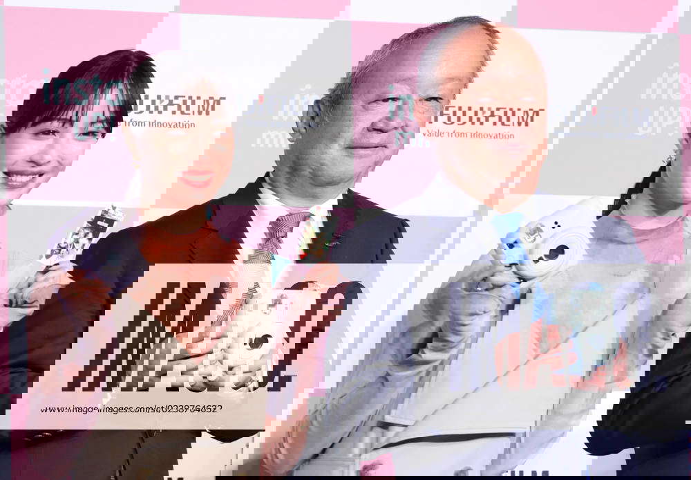 Tokyo, Japan - Japanese actress Suzu Hirose and Fujifilm president Teiichi Goto display the company