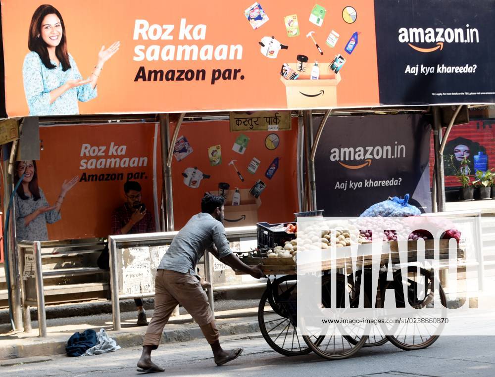 Amazon Logo In Mumbai A vegetable seller pushes a cart, passes by an ...