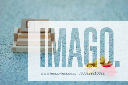 Wooden calendar with numbers of days in cubes and cards with the months ...