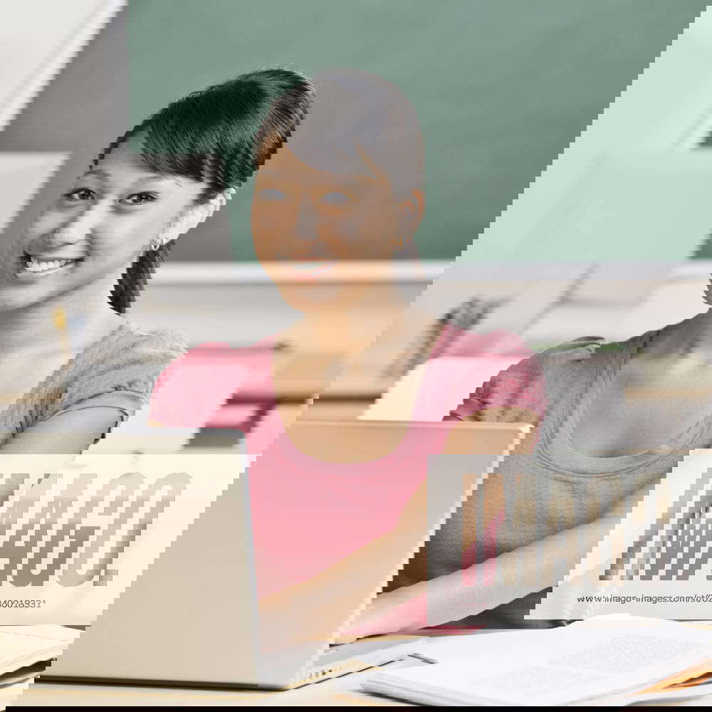 Young woman on computer in classroom. Square format