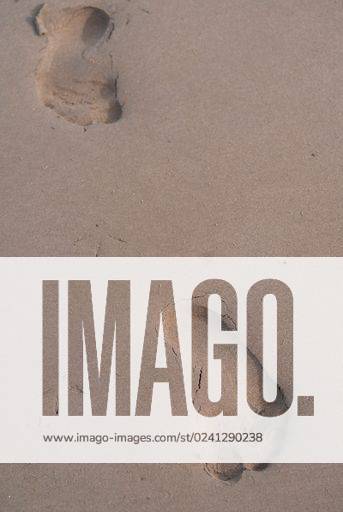 A closeup of child s footsteps on the sand *** einer closeupe des Kind ...