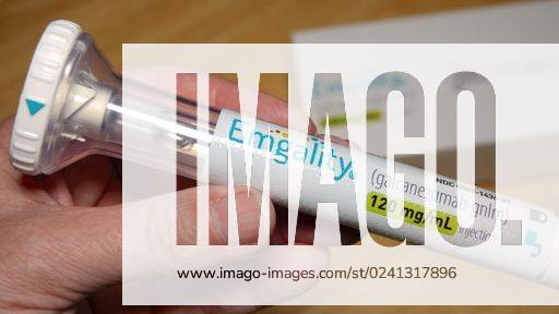 Close up of hand holding Emgality injection. Emgality (galcanezumab ...